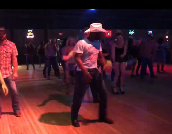 Cowboy in white hat shakes up the dance floor when he starts to wobble