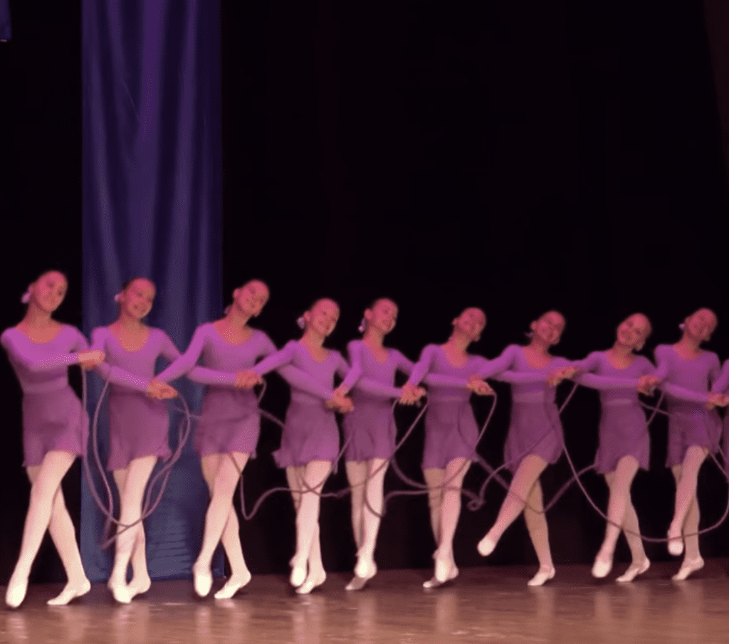 12 young girls perform an intricate dance routine involving…jump ropes?