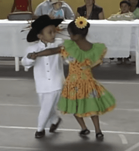 Couple kids take the stage and performs traditional colombian dance ...