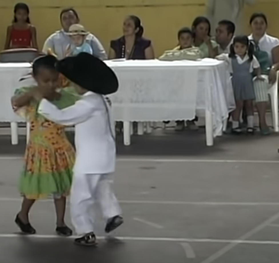 Couple kids take the stage and performs traditional colombian dance ...
