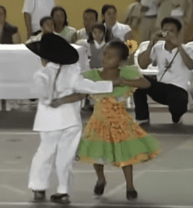 Couple kids take the stage and performs traditional colombian dance ...