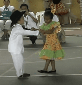 Couple kids take the stage and performs traditional colombian dance ...