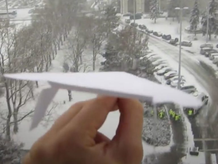 Paper plane makes perfect landing on moving train in the snow