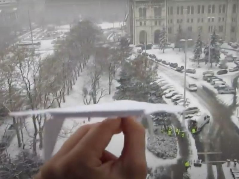 Paper plane makes perfect landing on moving train in the snow