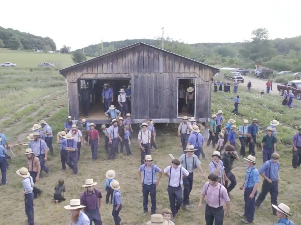 Group of Amish men move entire building using only their brute strength